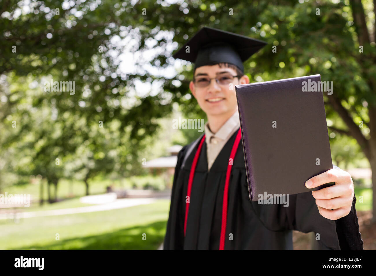 Highschool graduate after graduation caremony in the park Stock Photo ...