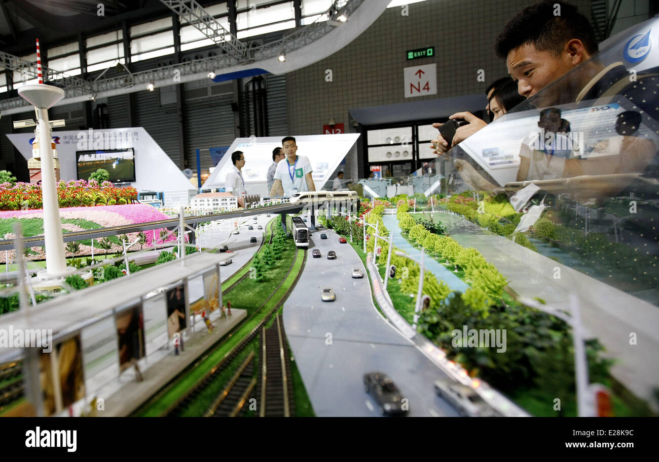 Shanghai, China. 17th June, 2014. Visitors take photo of transportation ...