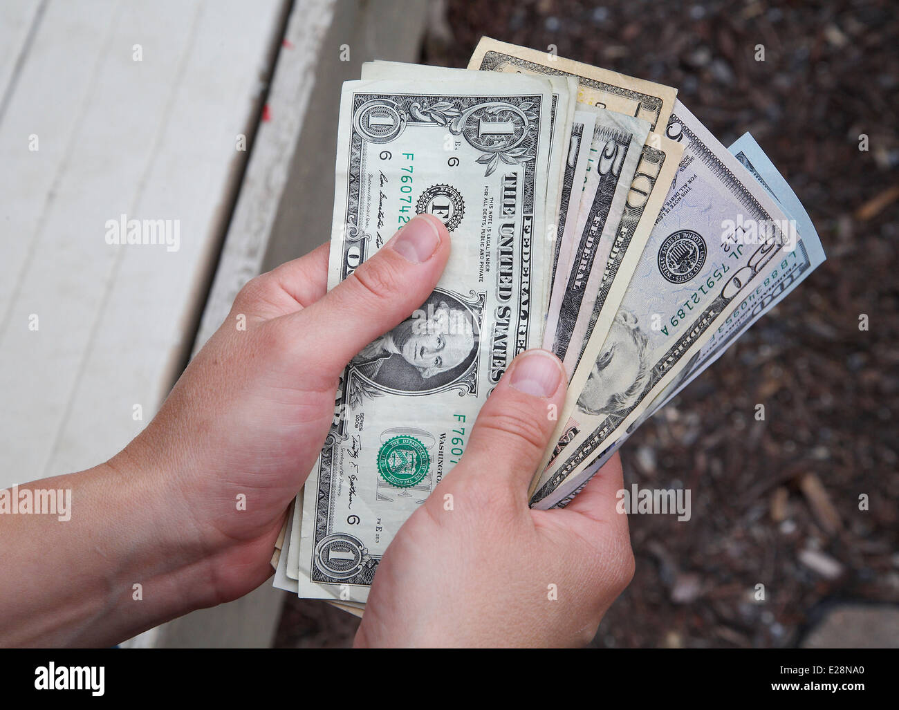 Hands counting us dollar bills hi-res stock photography and images - Alamy