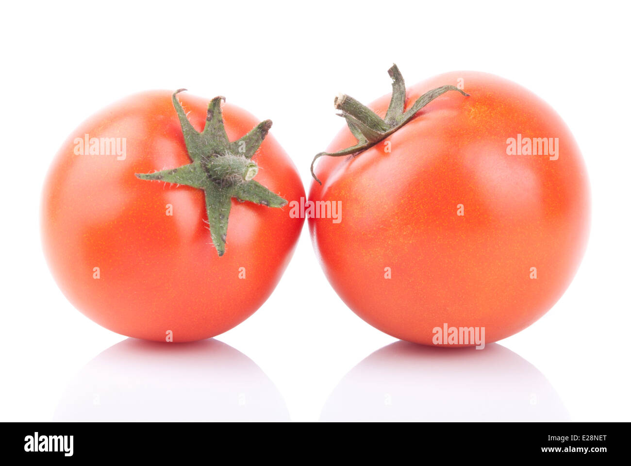 Two red tomatoes isolated on a white background Stock Photo - Alamy