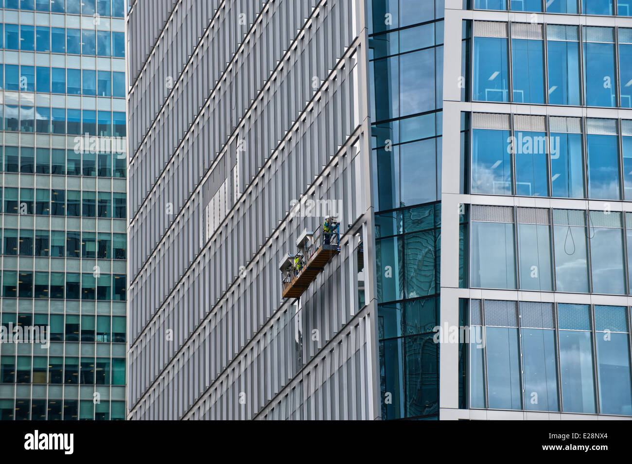 Workers clean skyscraper glazing from a cradle Stock Photo - Alamy