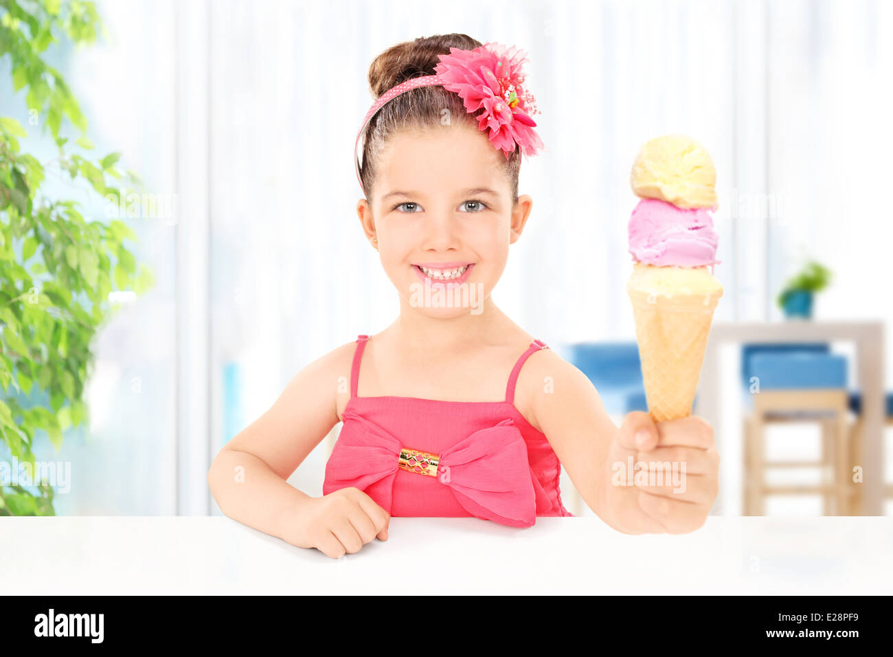 Girl holding ice cream sitting in the living room at home Stock Photo ...