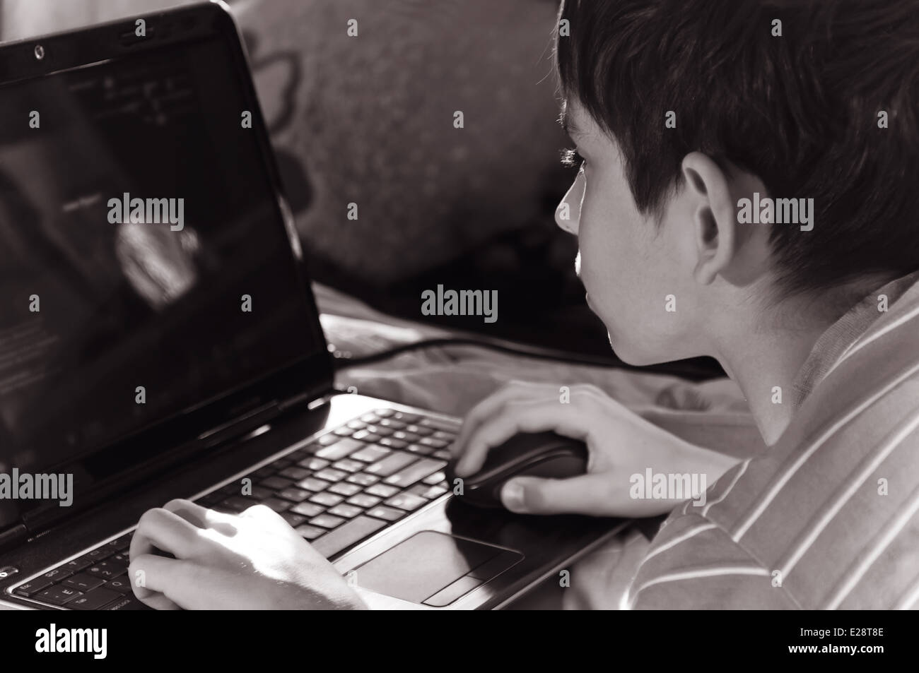Close up of young boy staring at laptop screen Stock Photo - Alamy