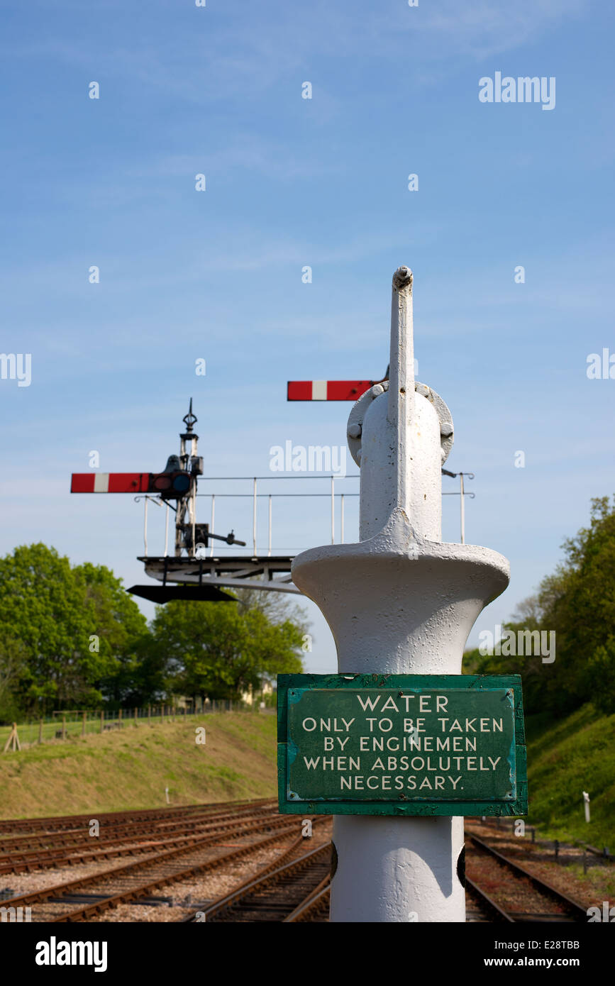 Signals and an engine water sign on a railway Stock Photo - Alamy