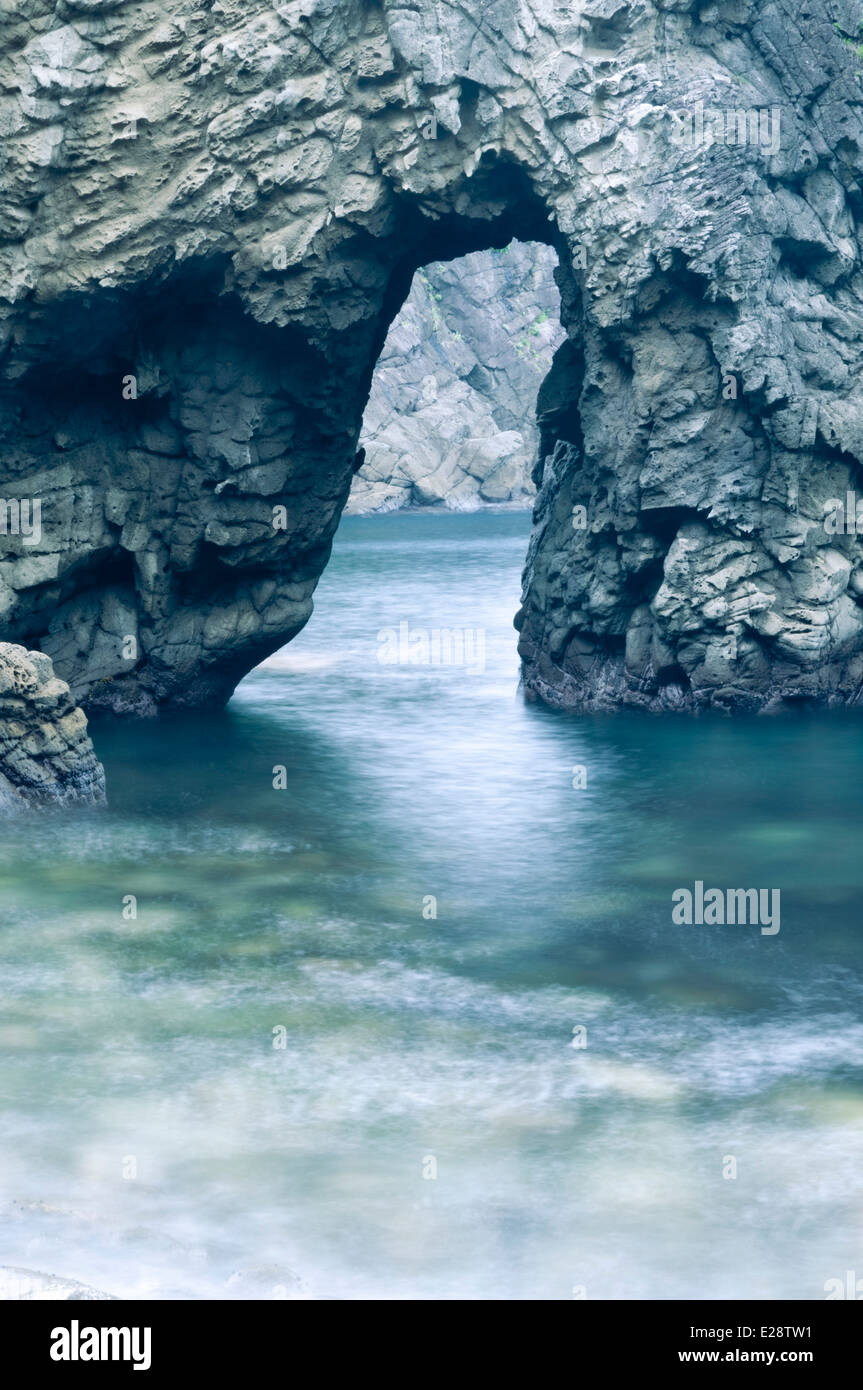 scenic rock with cavern on Japanese seaside by twilight Stock Photo - Alamy
