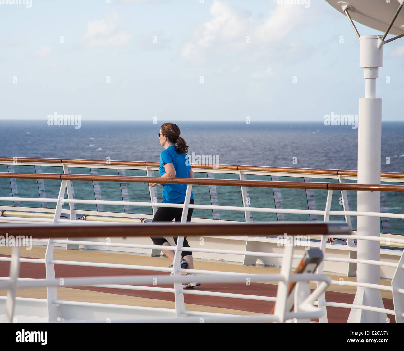 A woman running on the track of a luxury cruise ship Stock Photo - Alamy
