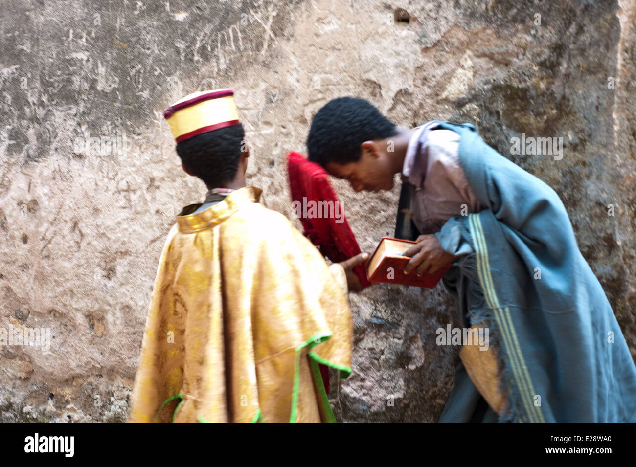 Boy participating in a mass bowing down before an image of Jesus ...