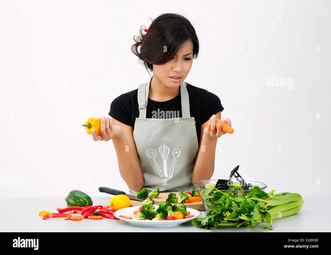 Young girl trying to cook Stock Photo - Alamy