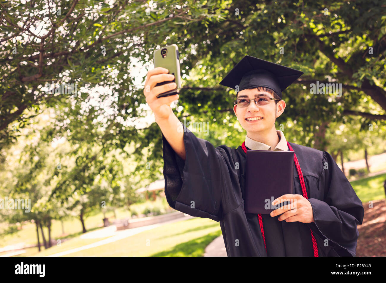 Highschool graduate after graduation caremony in the park Stock Photo ...