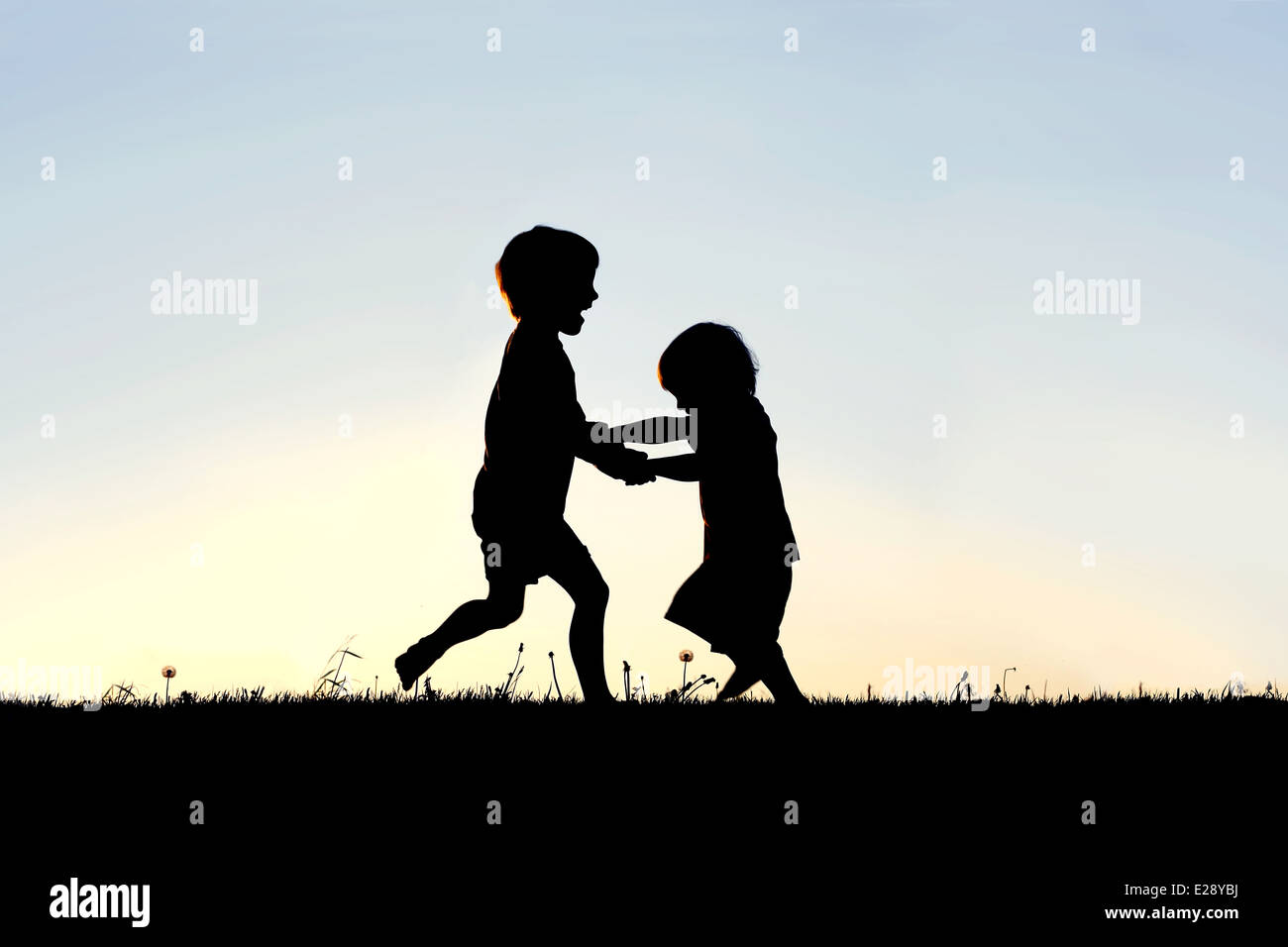 Two Children Holding Hands Silhouette