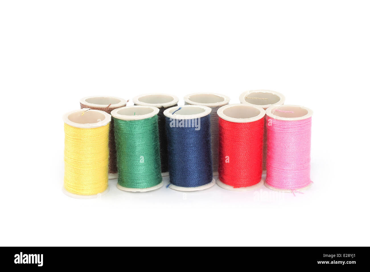 Color bobbins of thread on white background Stock Photo - Alamy