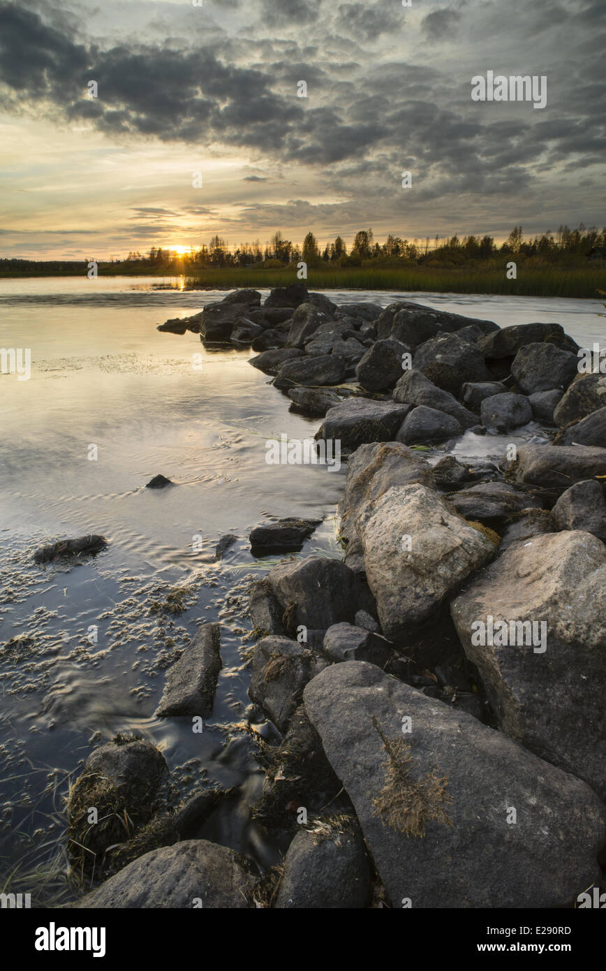 View of rocks and lake at sunset, Muonio, Lapland, Finland, September ...