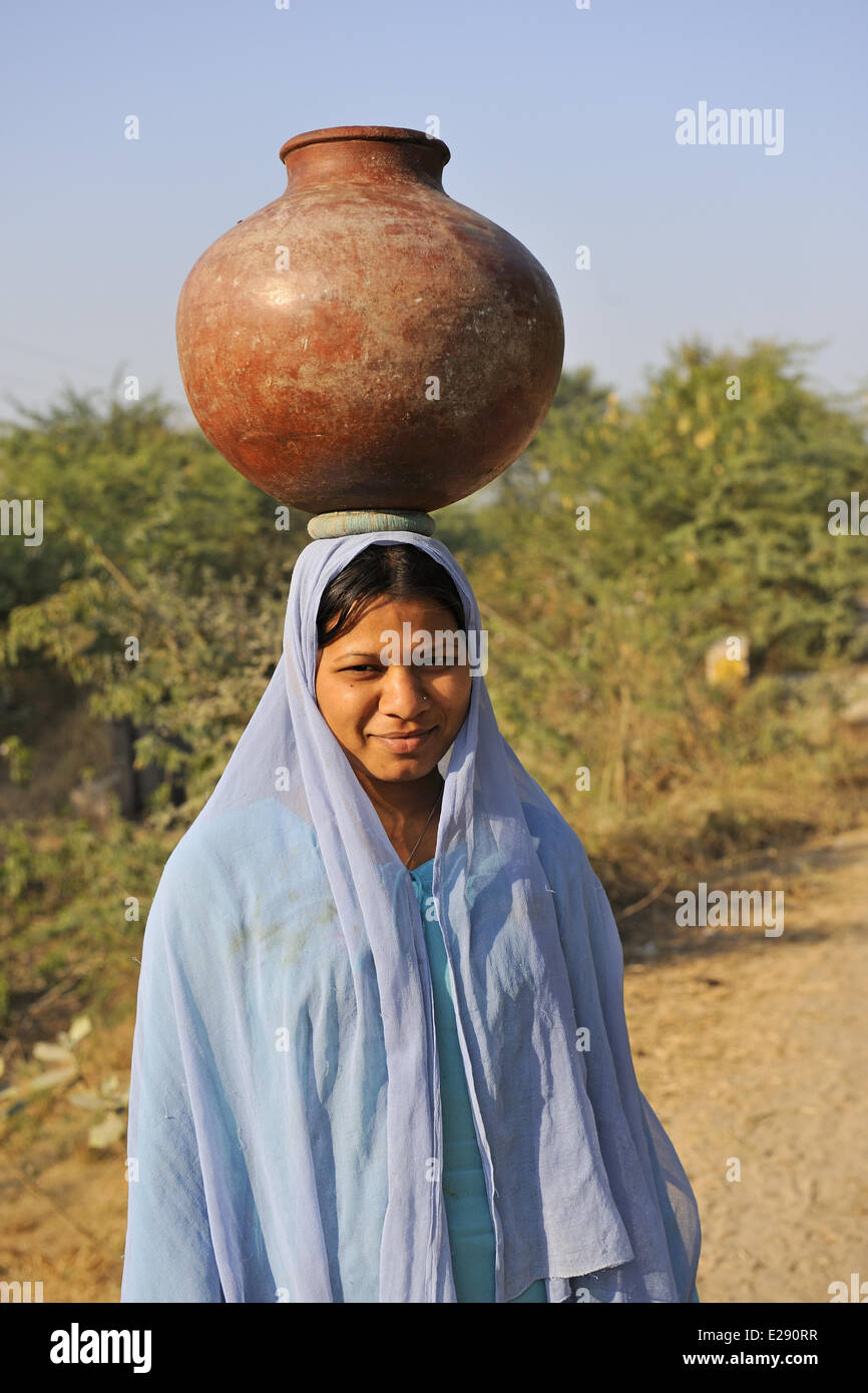 Indian girl carrying water container on head, near Bharatpur, Rajasthan ...