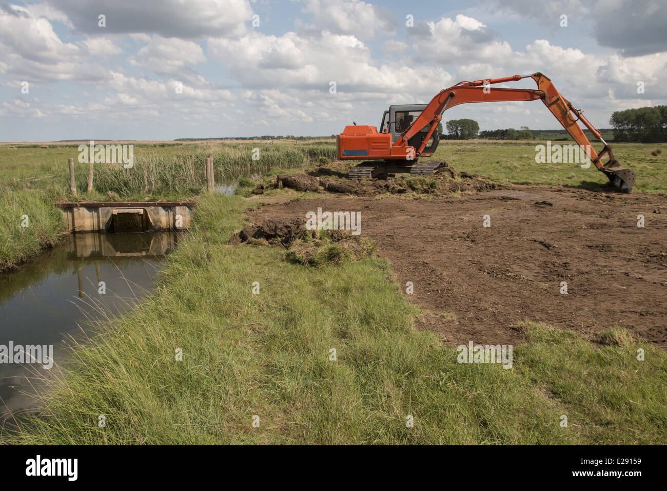 Using a digger for maintenance work on sluice gate at Deepdale Marsh ...