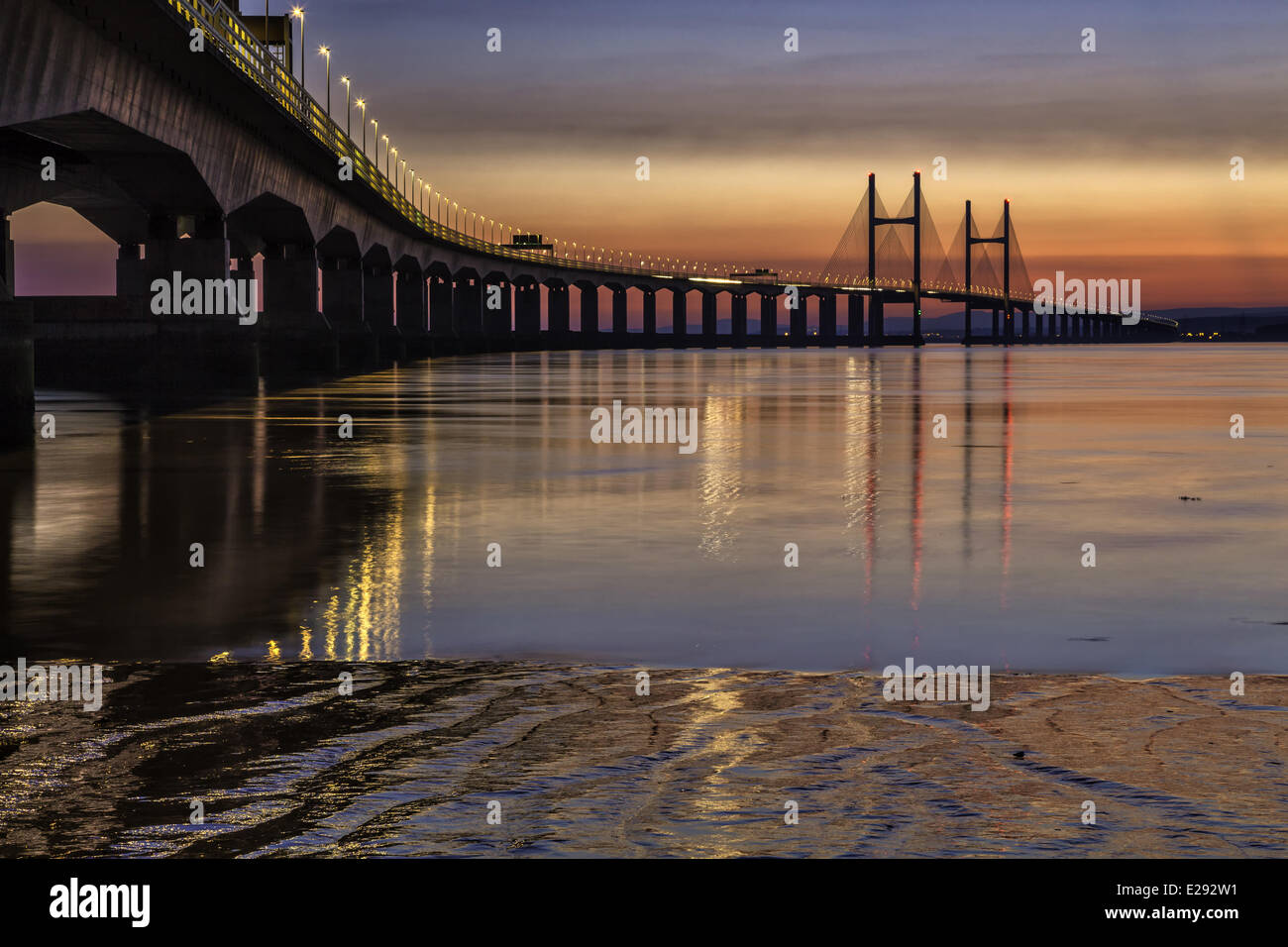 View of road bridge over river at sunset, viewed from Severn Beach ...