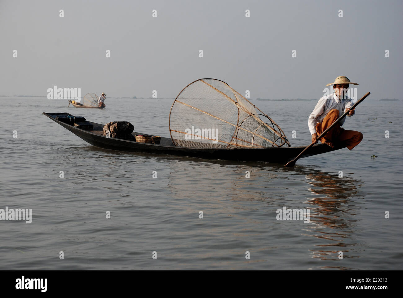 Traditional fishermen with fish traps in boats, Inle Lake, Shan State ...