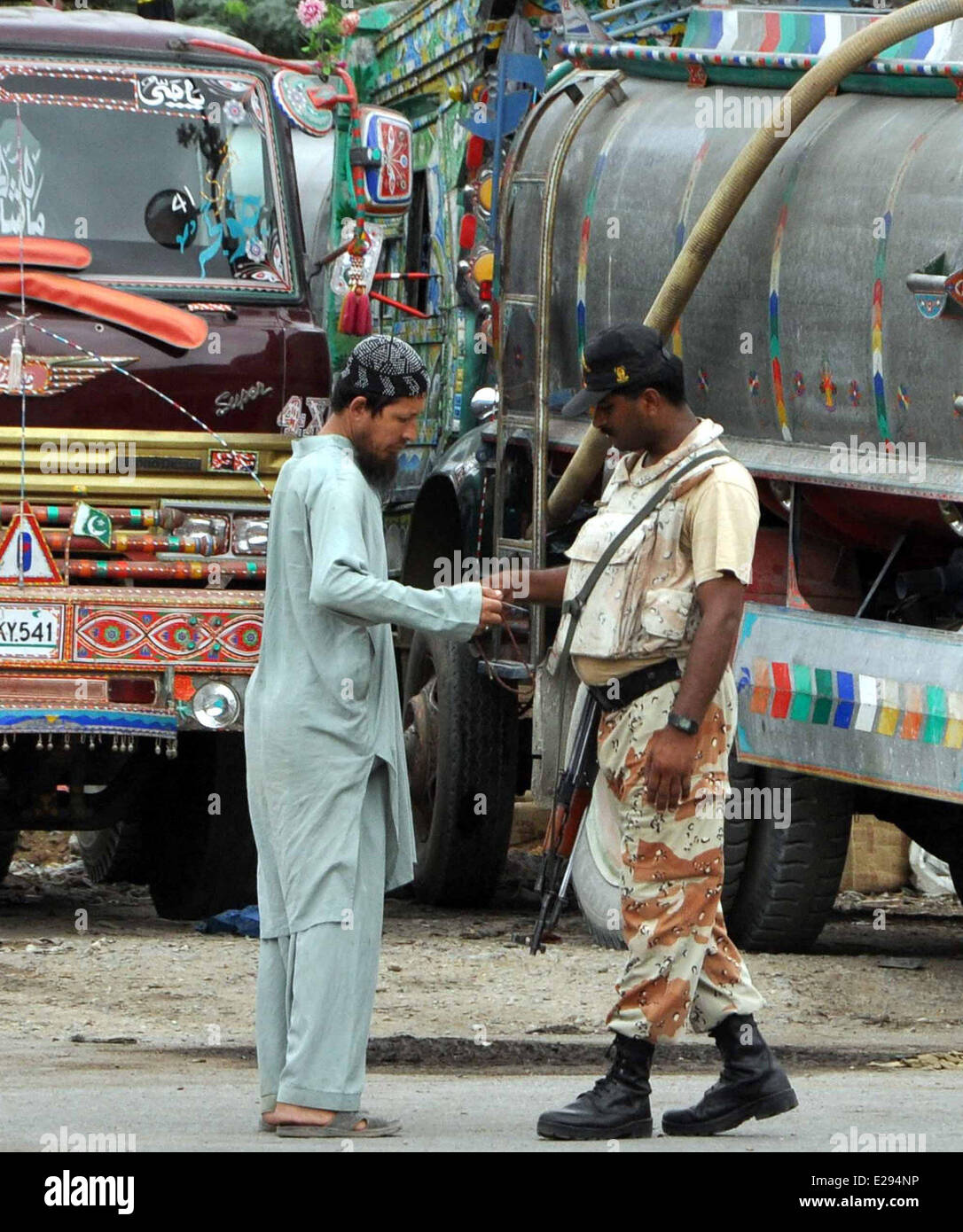 Karachi, Pakistani. 17th June, 2014. A Pakistani ranger checks the ...