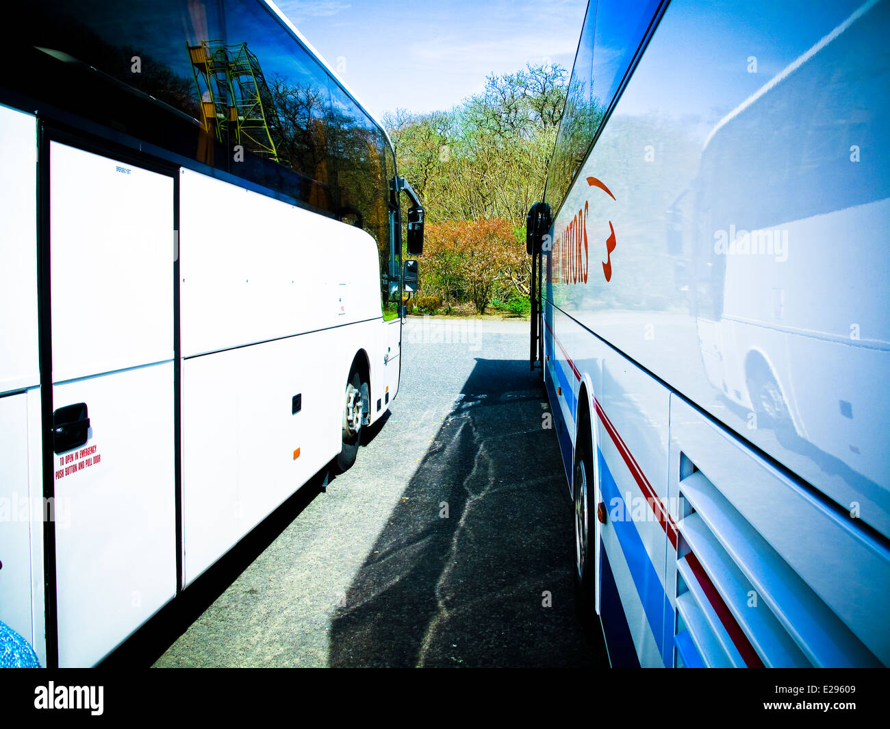 Two touring coaches parked side by side Stock Photo - Alamy