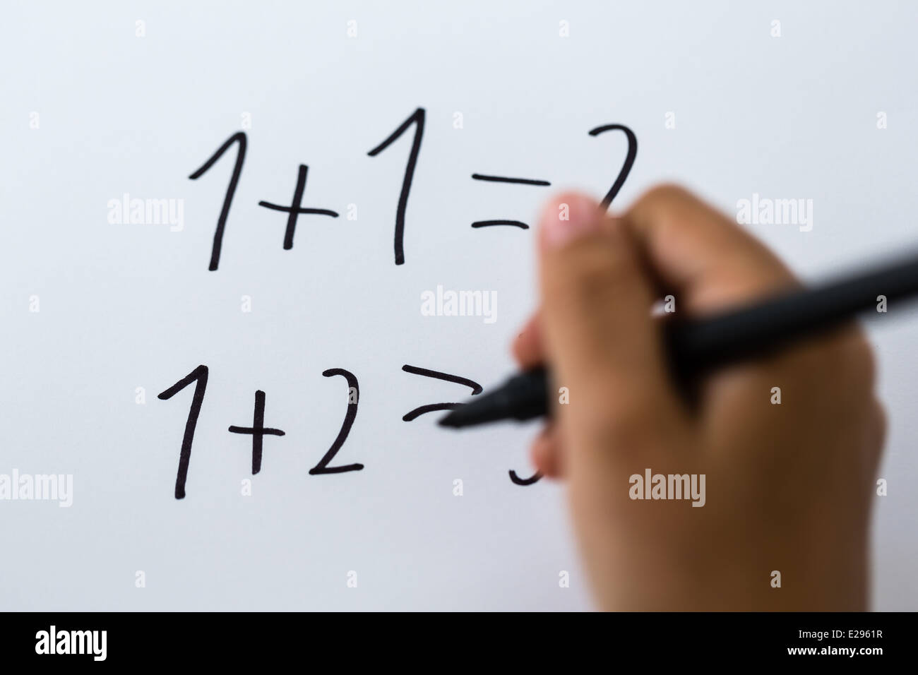 Close-up of simple math written on white piece of paper Stock Photo - Alamy