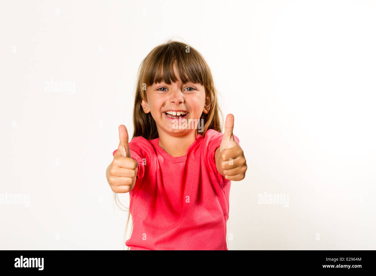 Young girl doing a happy gesture. Studio shot with white background ...