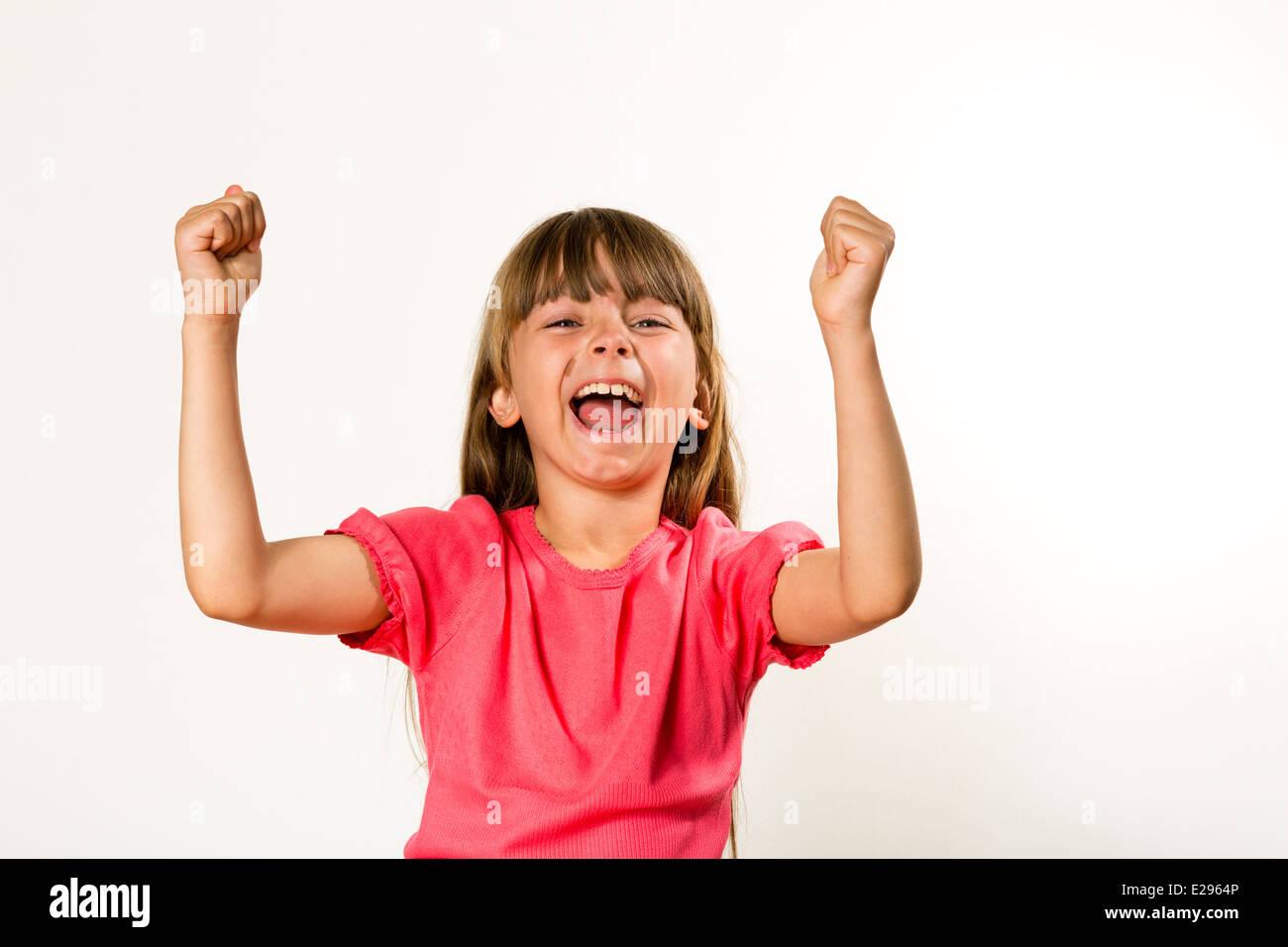 Young girl doing a happy gesture. Studio shot with white background ...