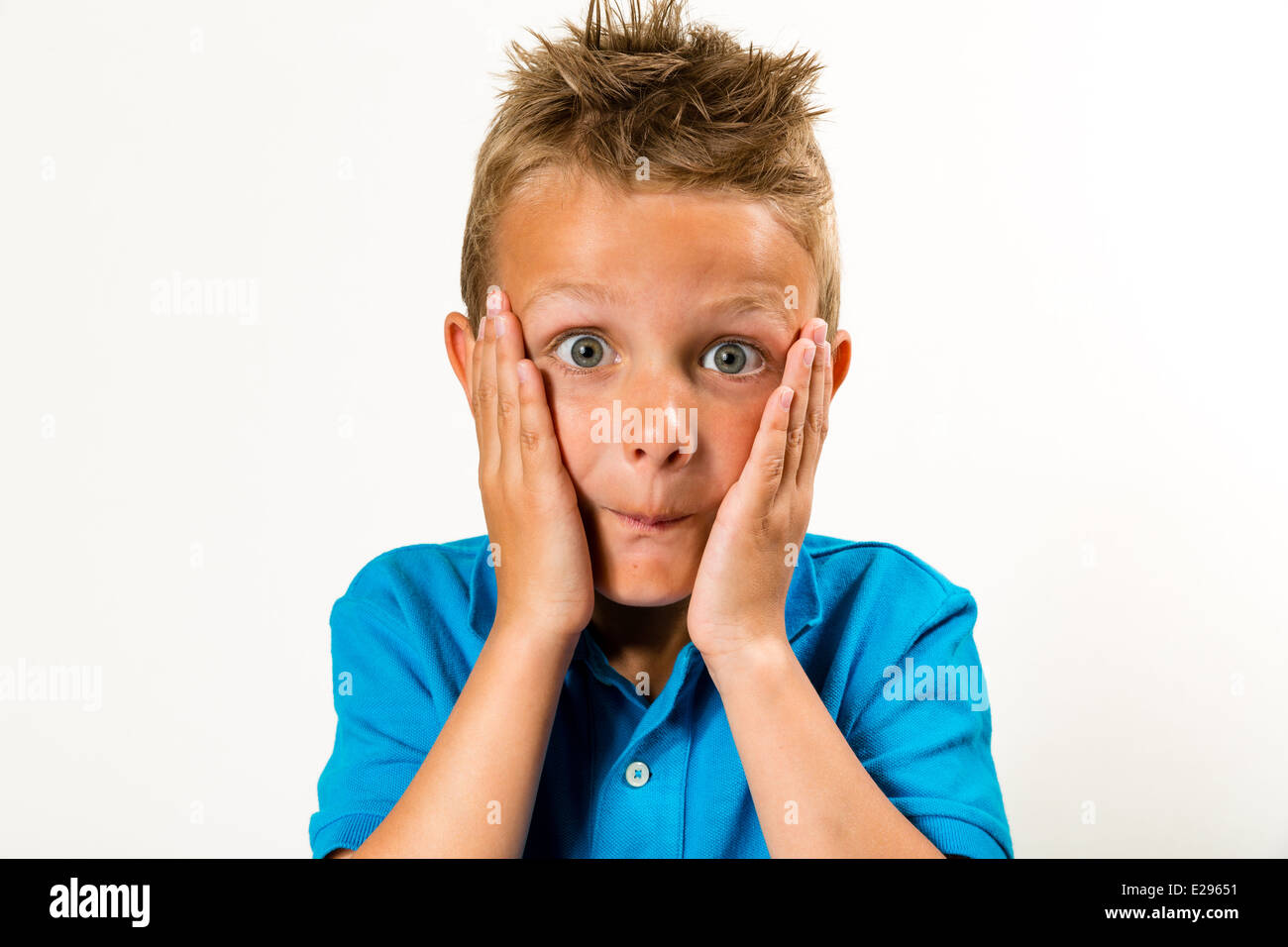 Caucasian boy with a silly face. Studio shot with white background ...