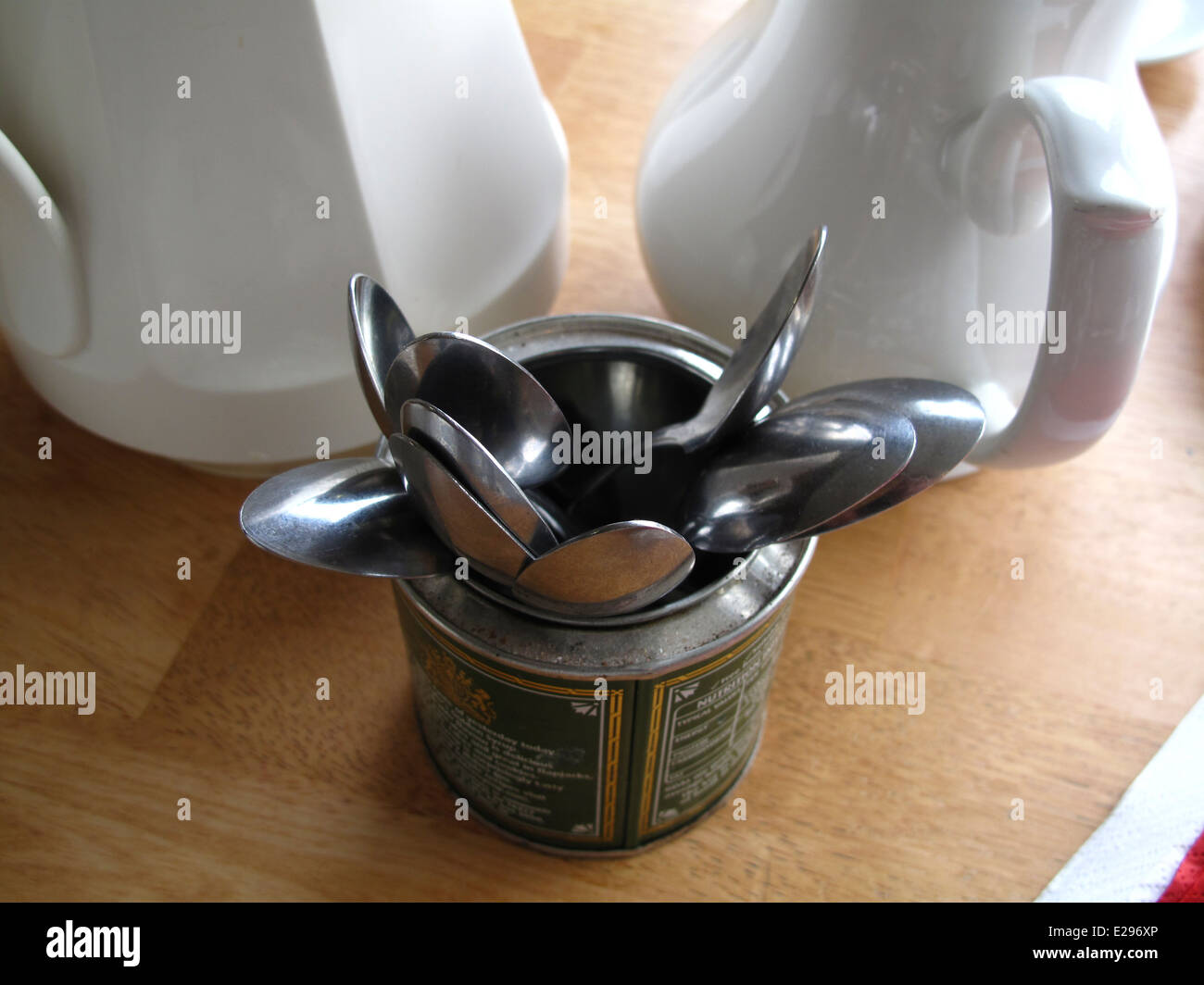 Teaspoons in tin beside teapot Stock Photo - Alamy