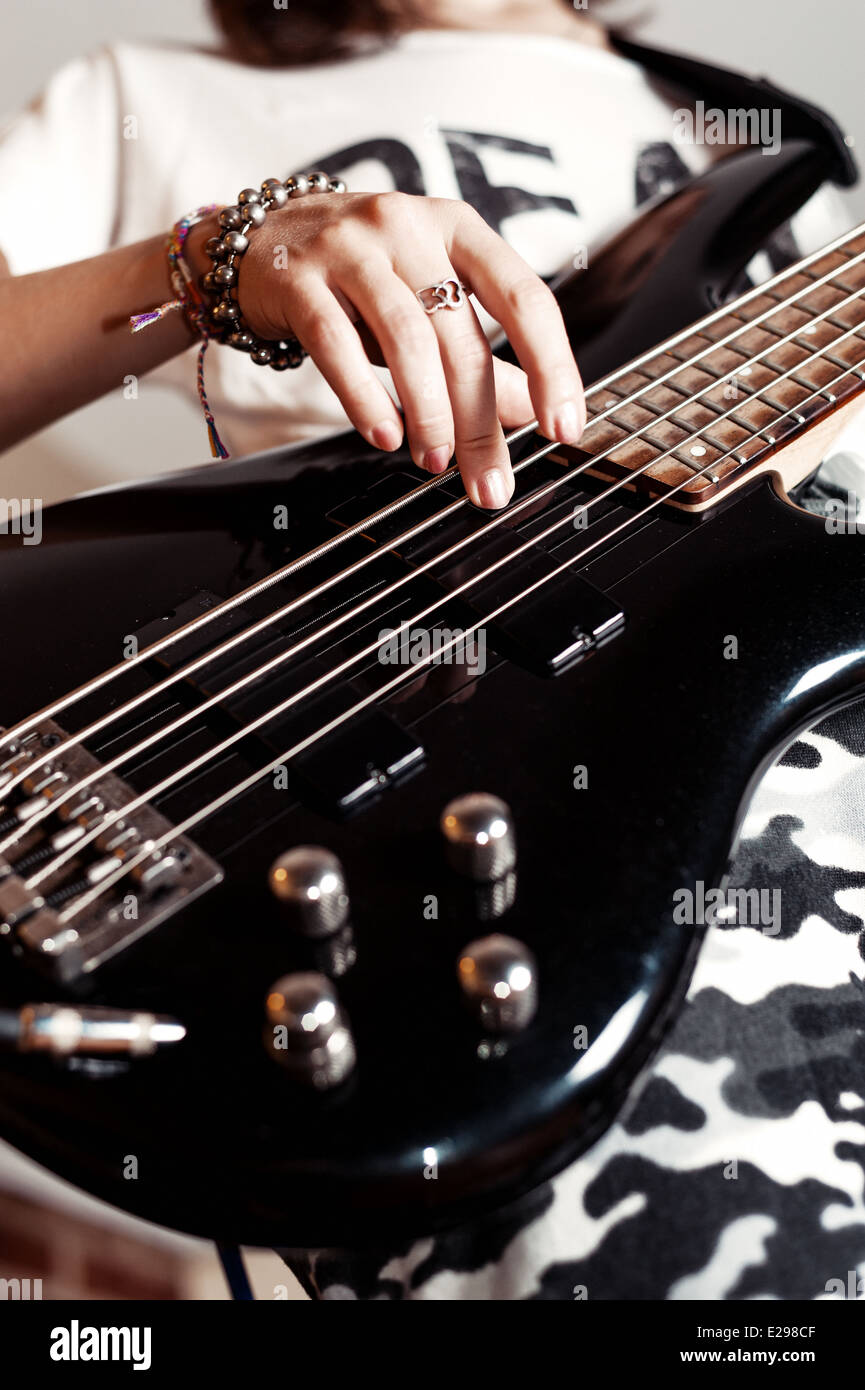 Girl playing bass guitar hi-res stock photography and images - Alamy