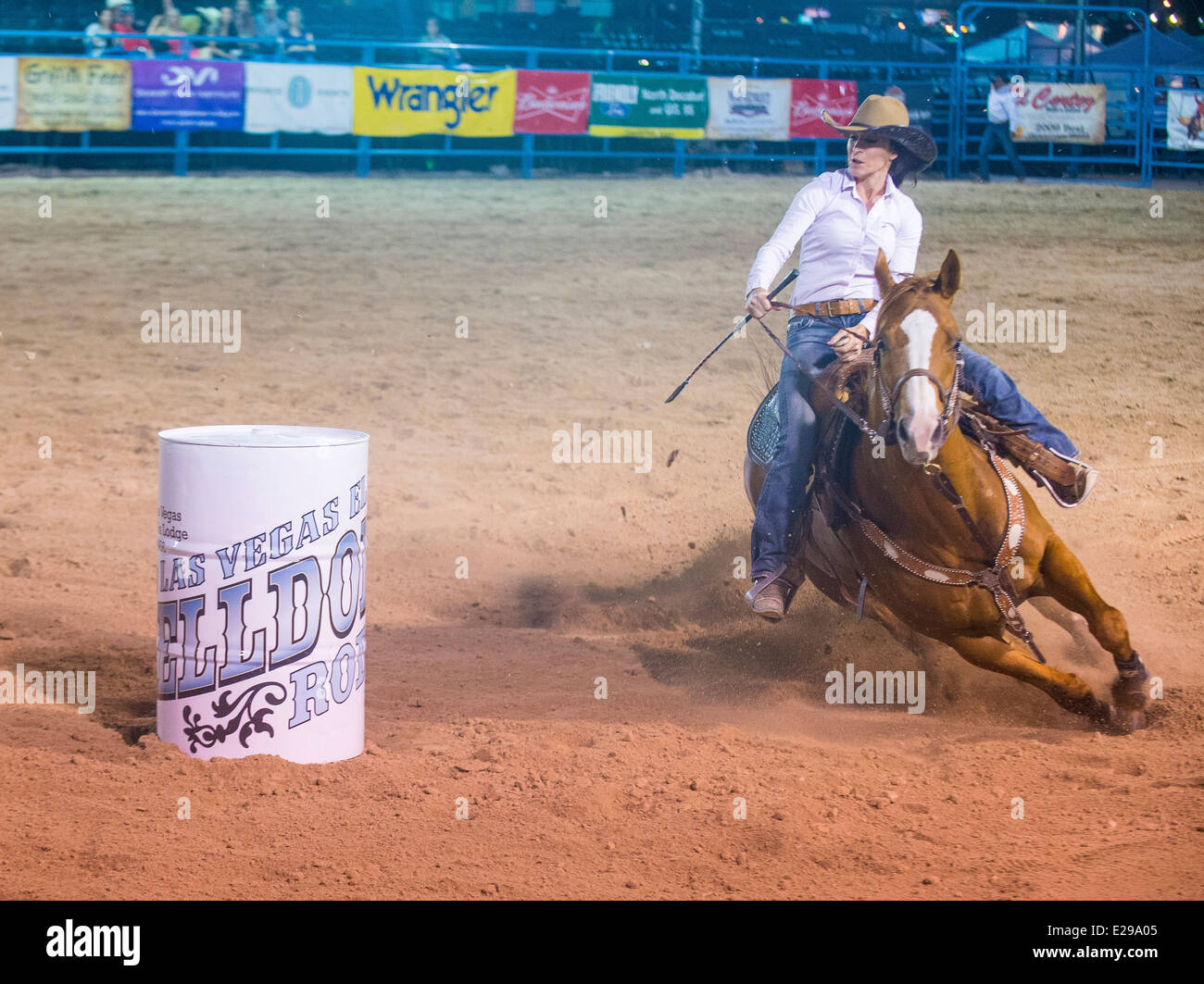 Cowgirl Participating in a Barrel racing competition at the Helldorado ...