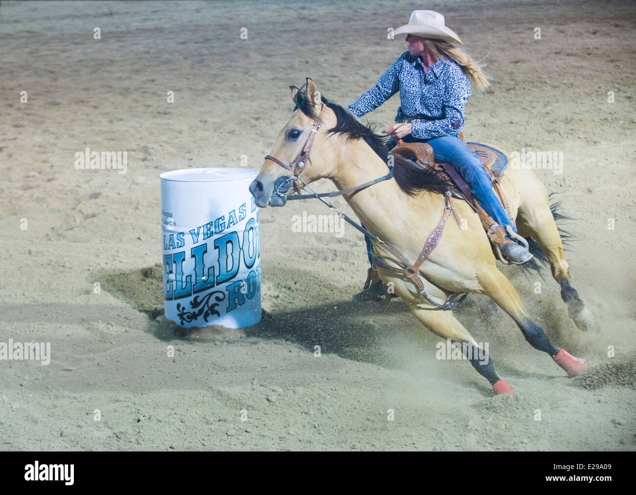 Cowgirl Participating in a Barrel racing competition at the Helldorado ...