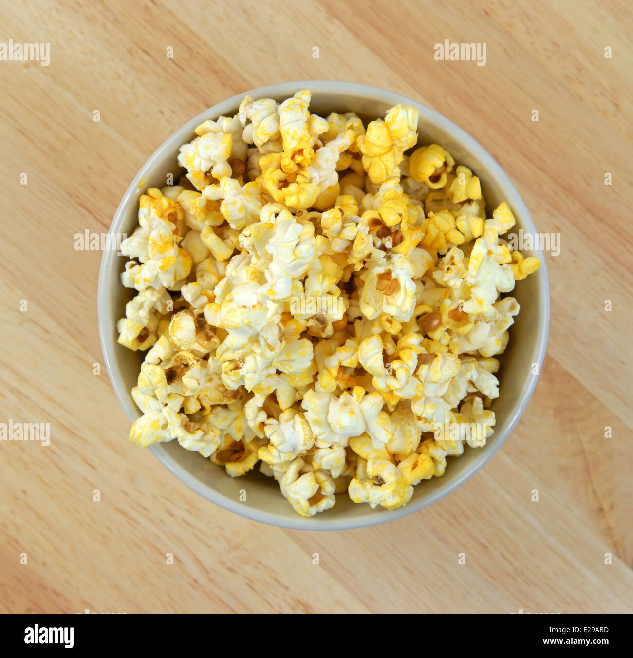 Top view of a full bowl of buttered popcorn on a wood table top Stock ...