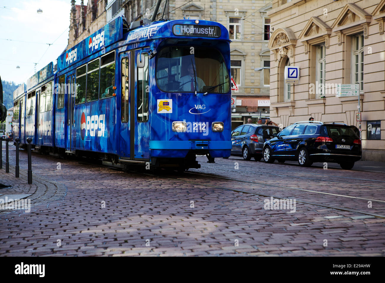 A blue tram crossing a street junction in Freiburg Germany Stock Photo ...