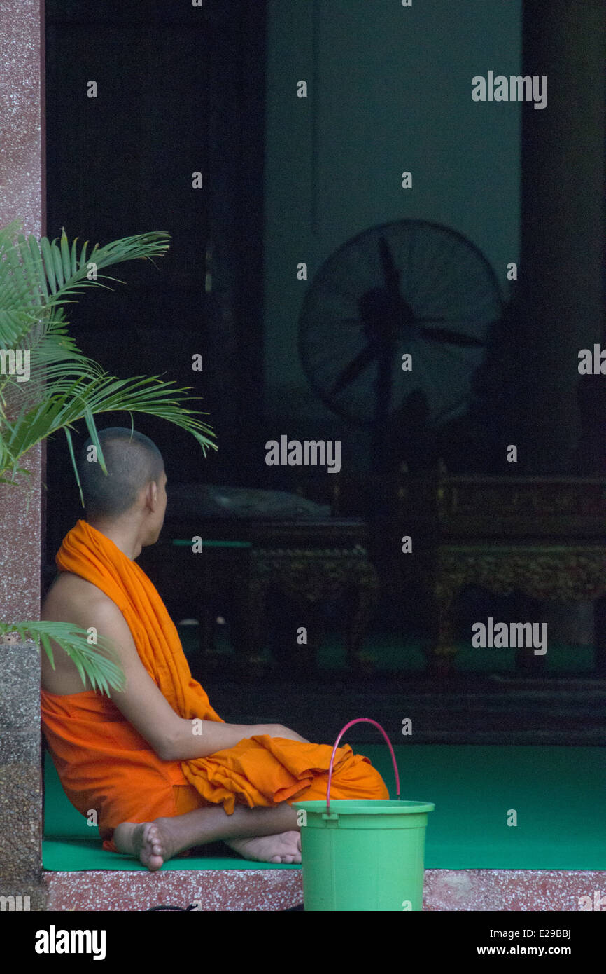 Monk relaxing outside a temple in Phnom Penh, Cambodia Stock Photo - Alamy
