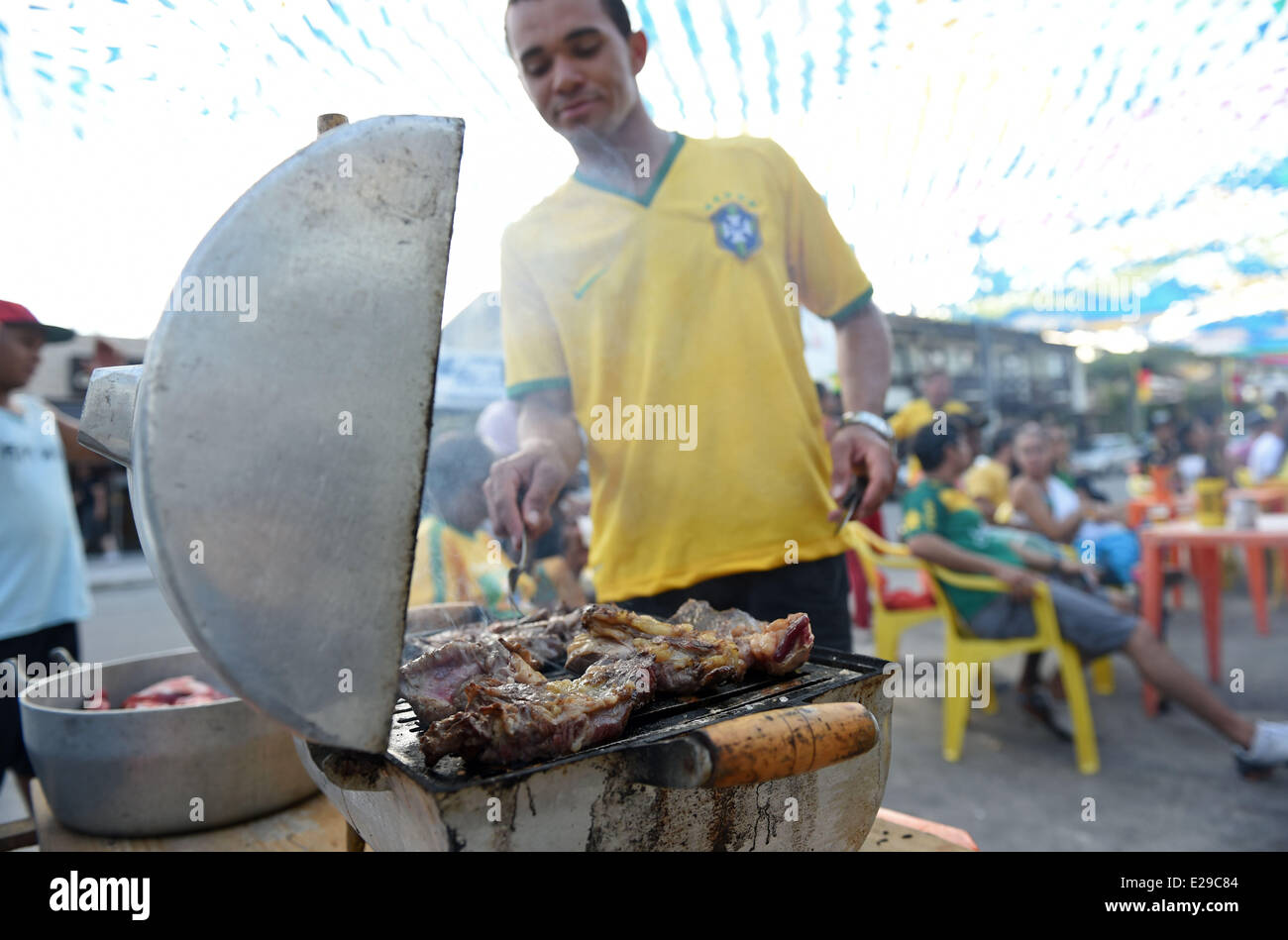 A man prepares a barbecue during public viewing for the FIFA World Cup ...