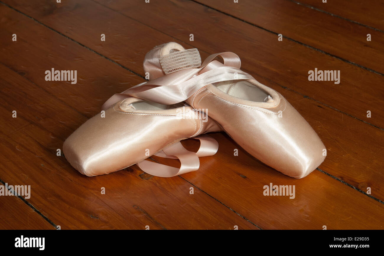 new pair of pointe shoes with ribbons for ballet on a wood floor Stock ...