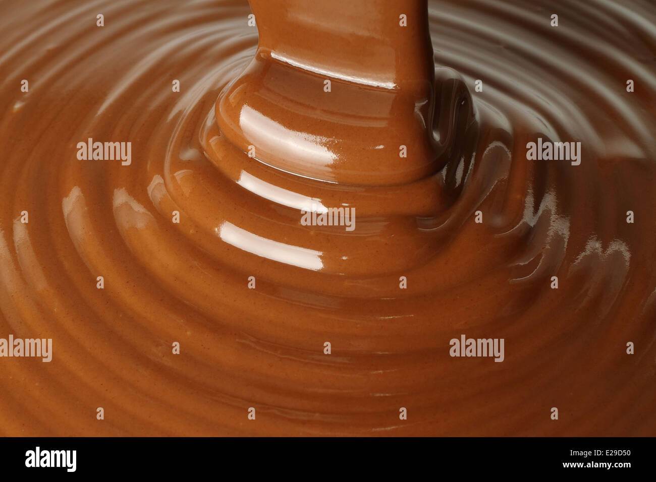 Melted milk chocolate flow Stock Photo - Alamy