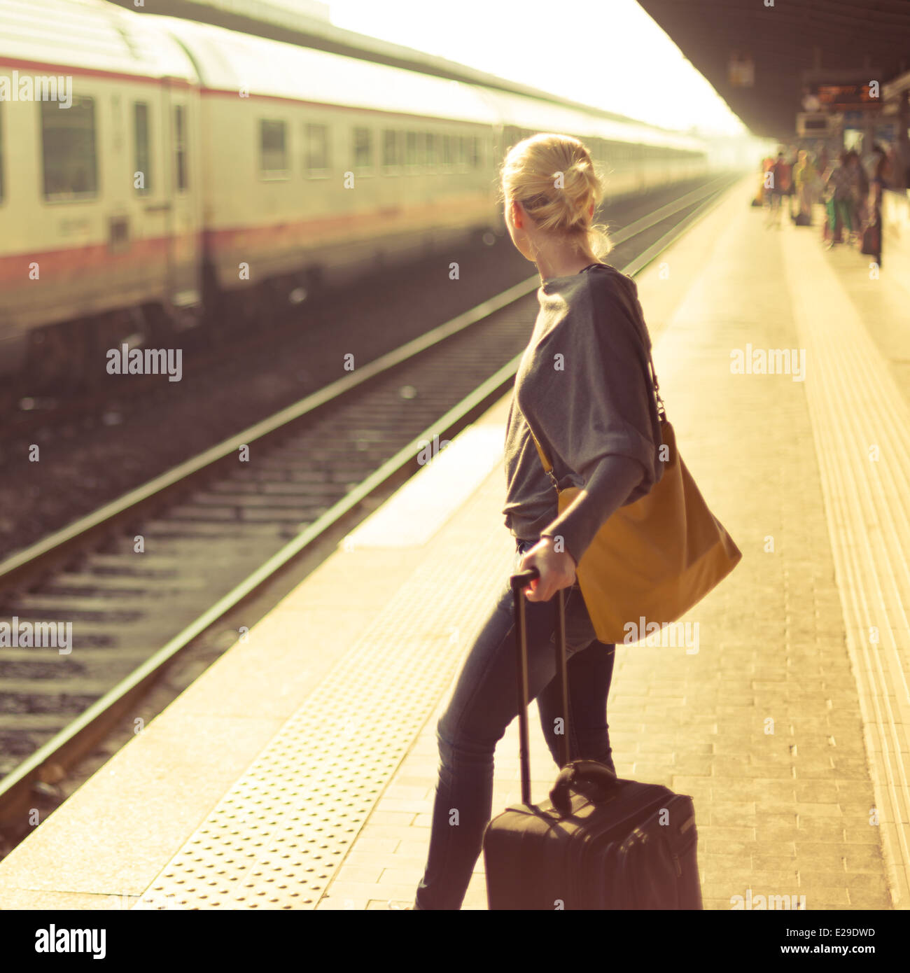 Lady waiting at the railway station Stock Photo - Alamy