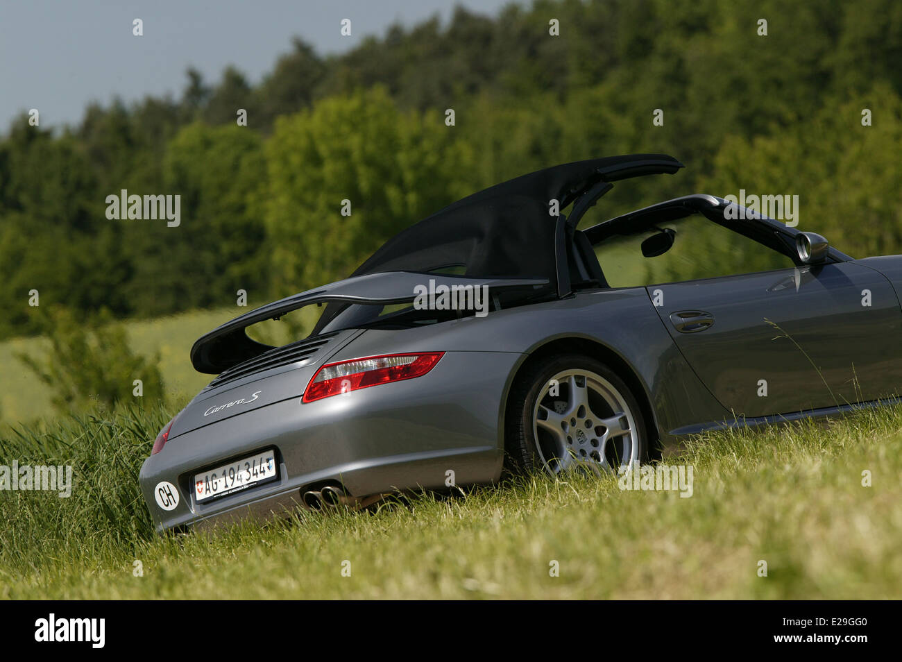 Porsche 997 Carrera S cabriolet in silver - driving with roof being ...