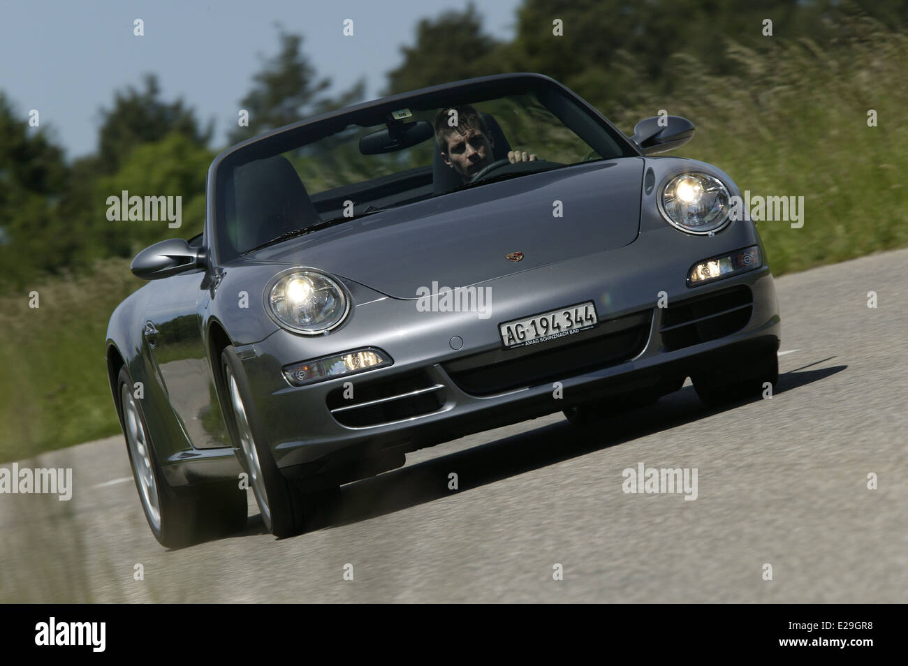 Porsche 997 Carrera S cabriolet front view with driver and roof hood ...