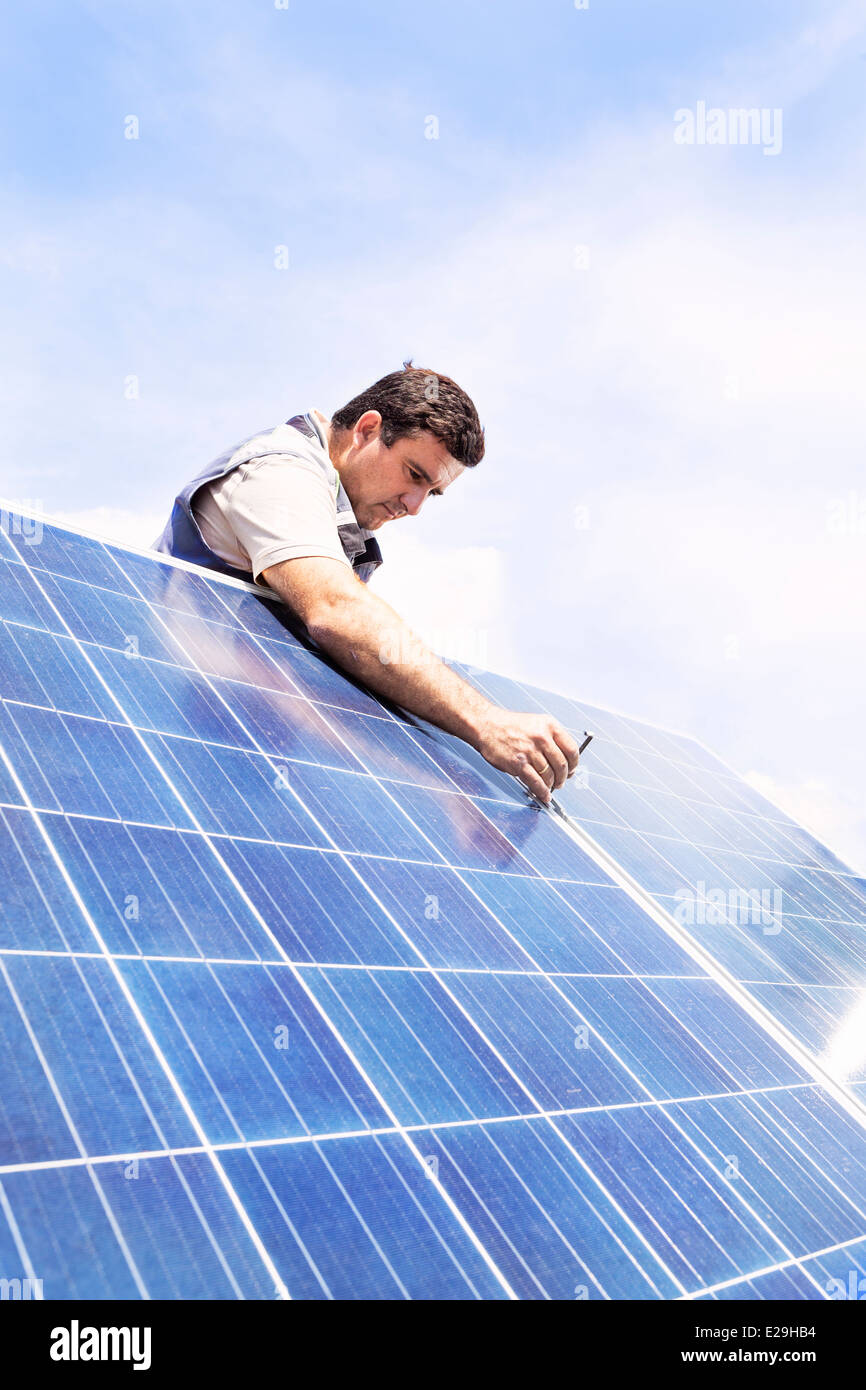 Professional installing electric solar panels Stock Photo - Alamy