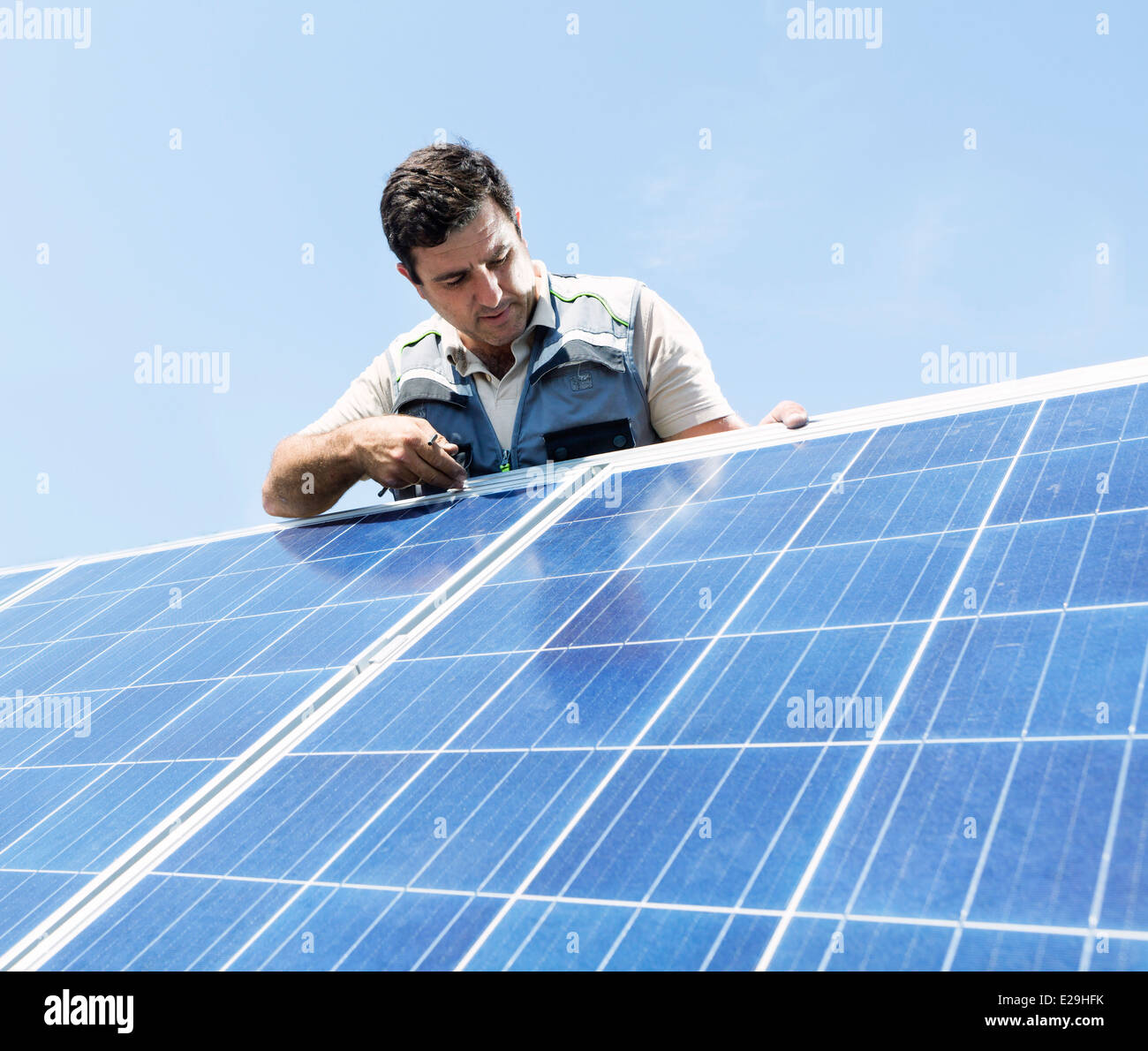 Professional installing electric solar panels Stock Photo - Alamy