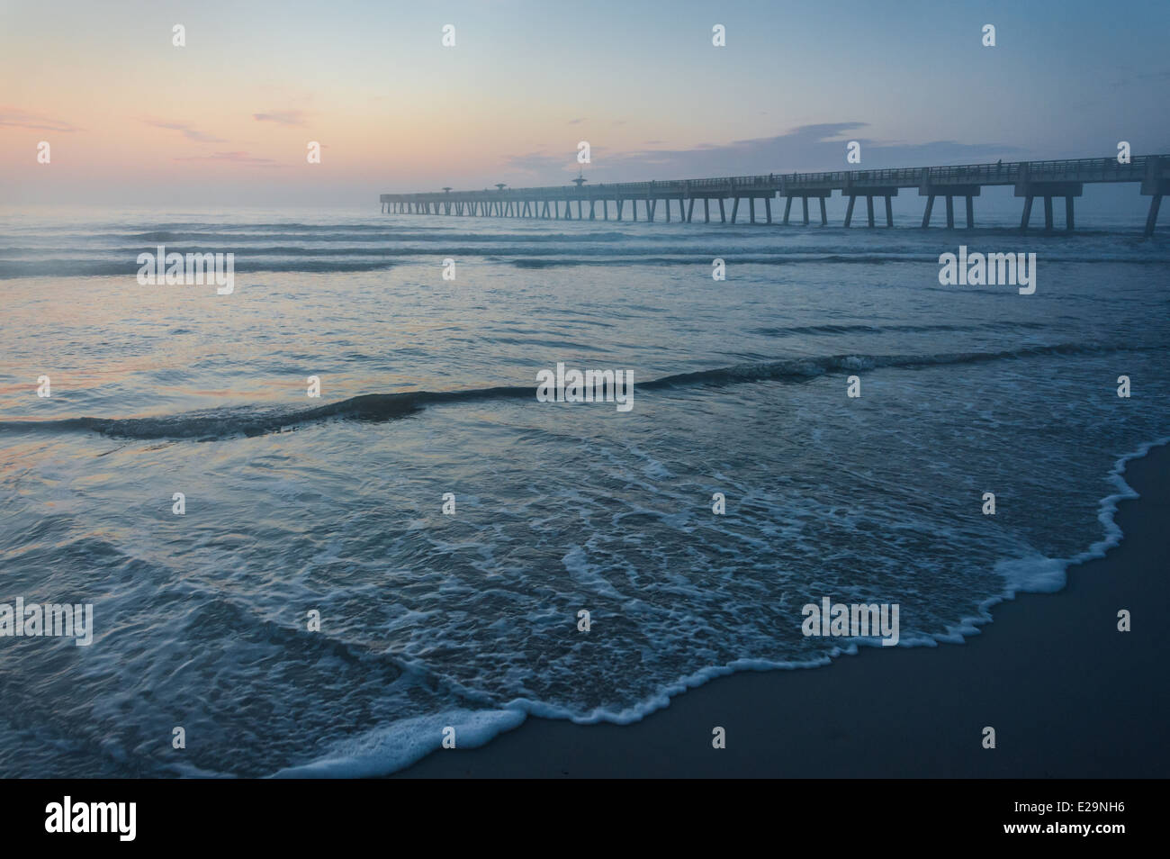 The colors of dawn paint the morning mist at the Jacksonville Beach ...