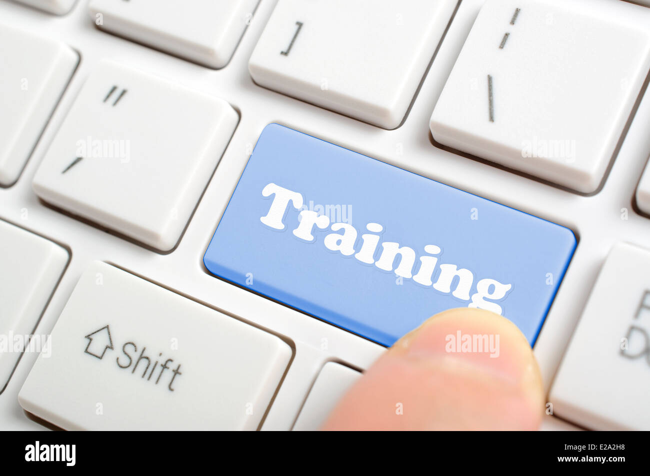 Pressing blue training key on keyboard Stock Photo - Alamy