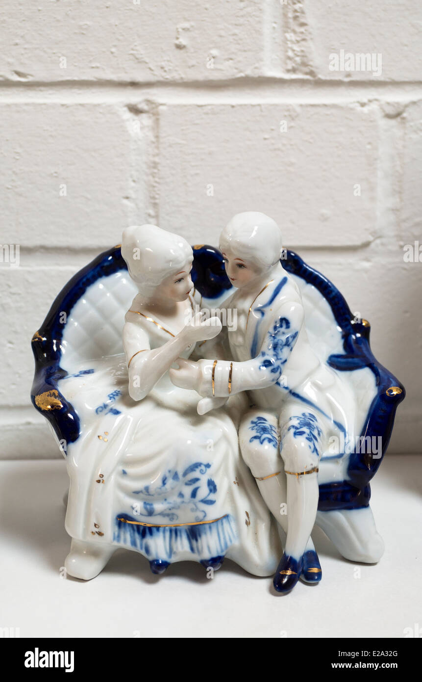 Loving couple on sofa in blue and white pottery Stock Photo - Alamy