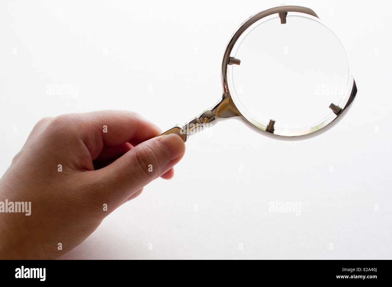 Woman's hand holding magnifying glass Stock Photo - Alamy