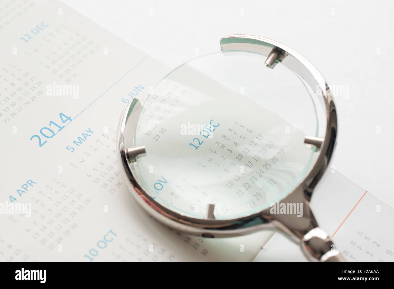Hand holding magnifying glass to checking calendar of December Stock ...