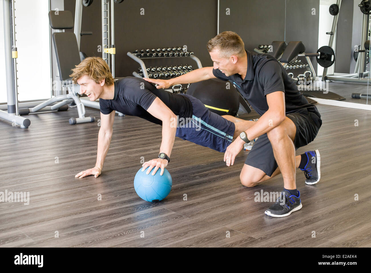 Personal trainer at work with trainee Stock Photo - Alamy