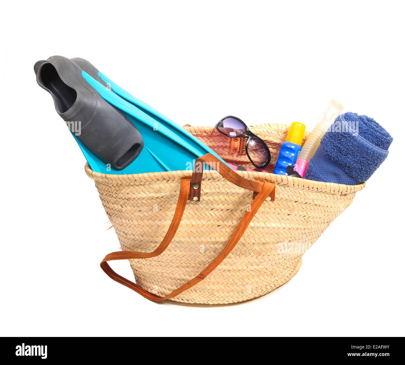 Vacation items in a wicker bag Stock Photo - Alamy