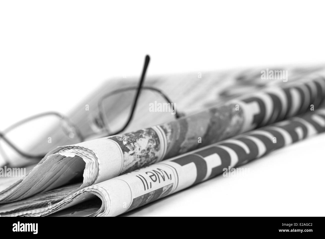 Newspaperfolded up with specs Stock Photo - Alamy