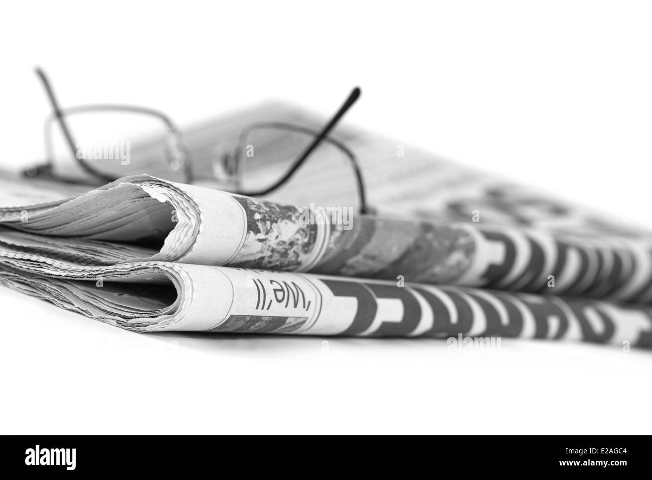 Newspaperfolded up with specs Stock Photo - Alamy